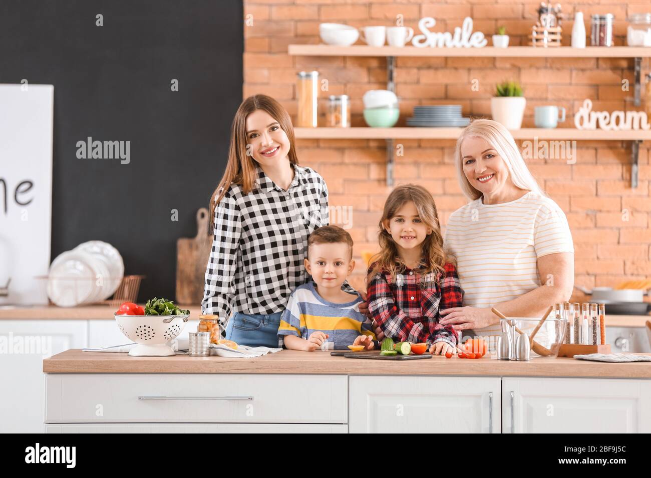 Big family cooking together in kitchen Stock Photo - Alamy