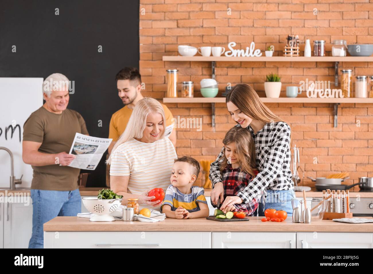 Big family cooking together in kitchen Stock Photo - Alamy