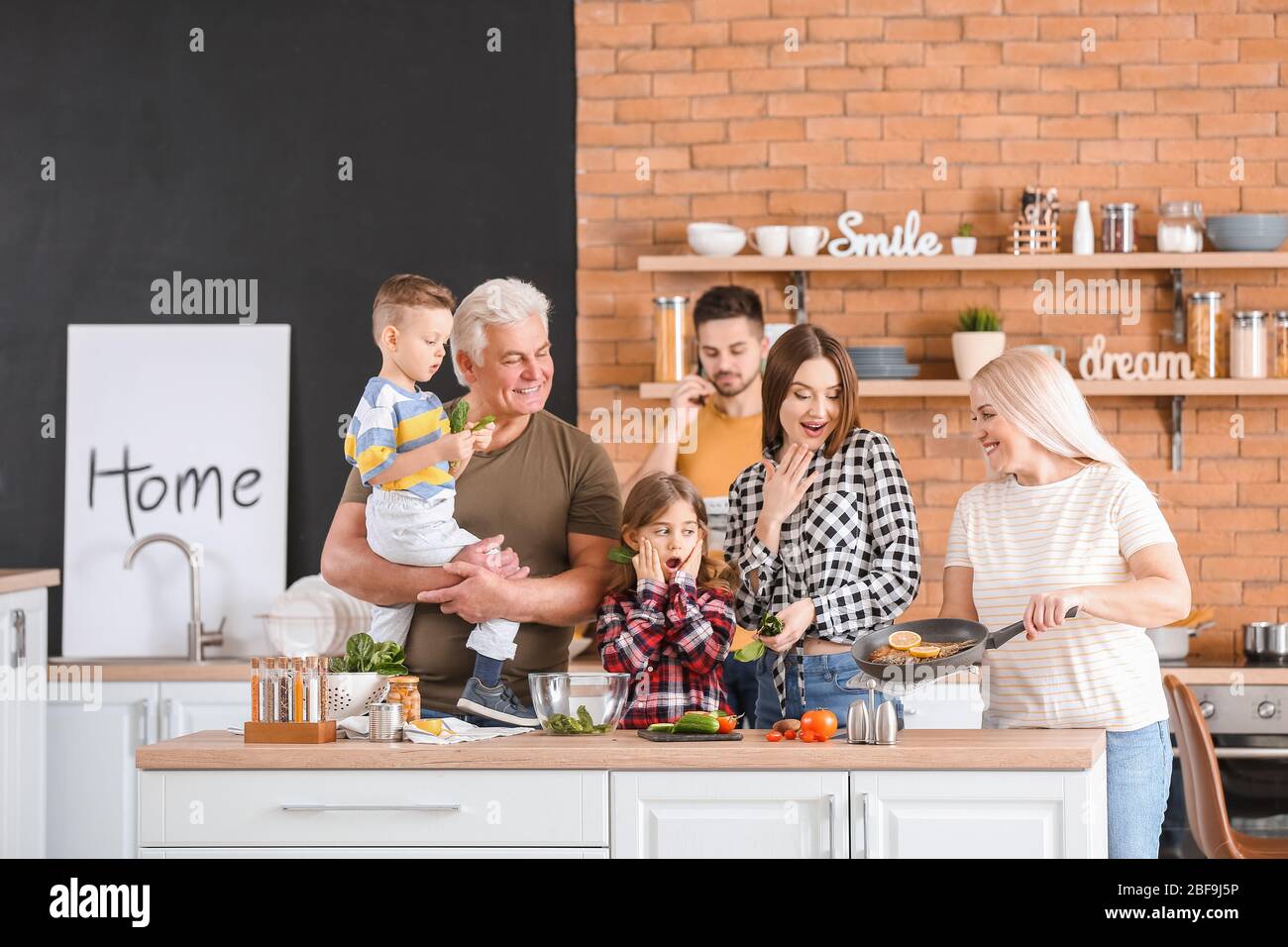Big family cooking together in kitchen Stock Photo - Alamy