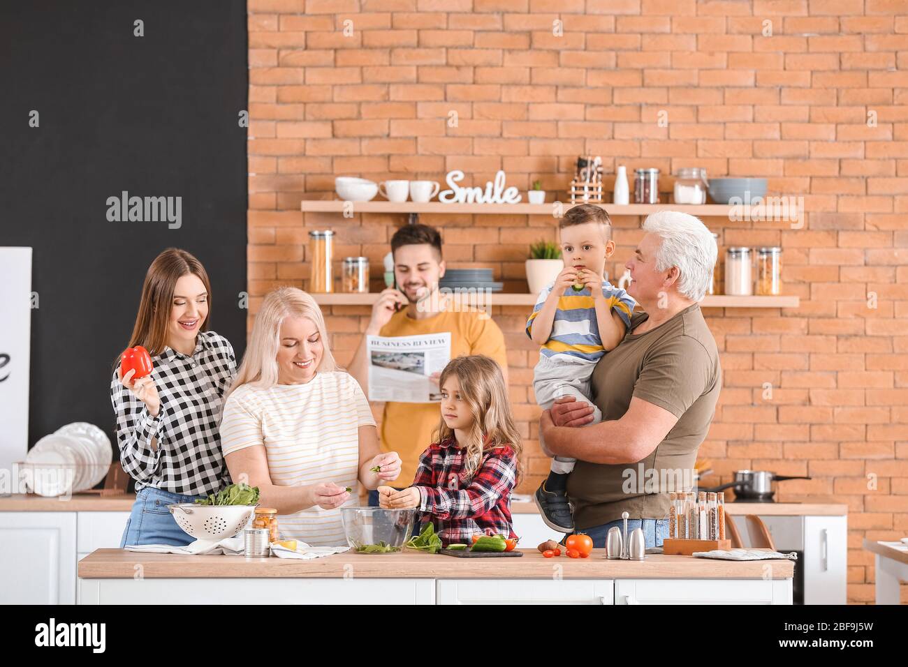 Big family cooking together in kitchen Stock Photo - Alamy