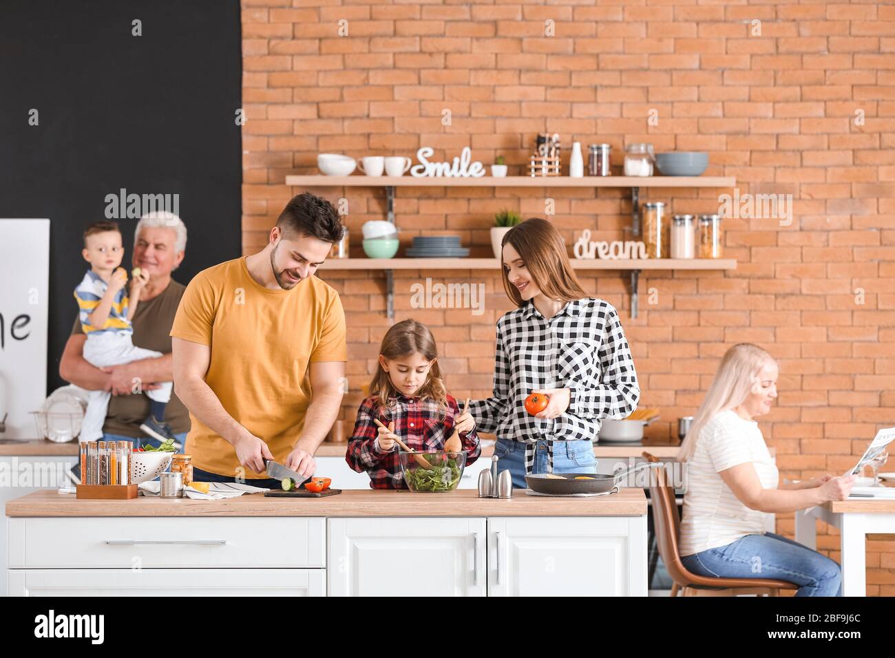 Big family cooking together in kitchen Stock Photo - Alamy