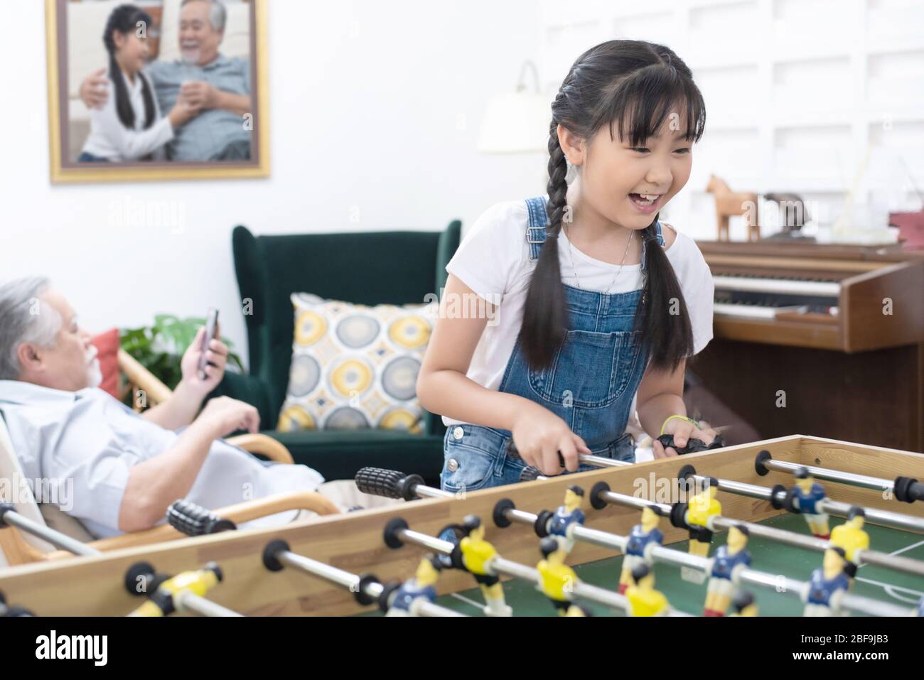 Young happy asian girl playing soccer table game together happiness ...