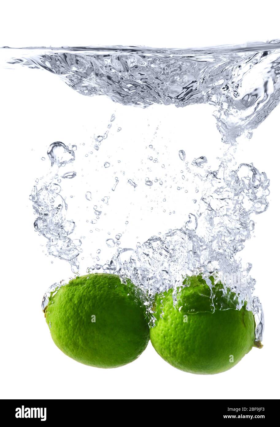Falling of fresh limes into water against white background Stock Photo ...