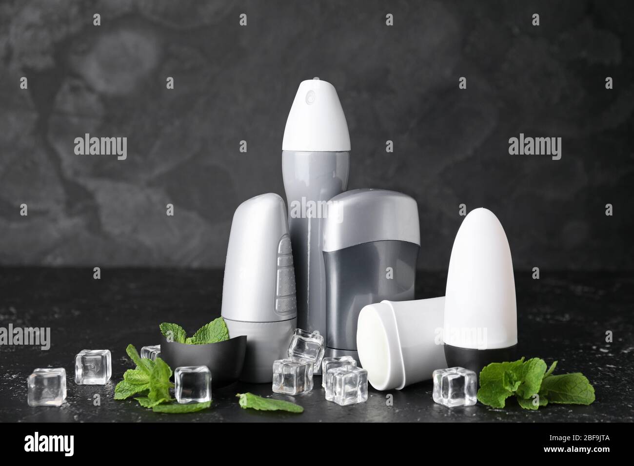 Different deodorants on dark background Stock Photo - Alamy