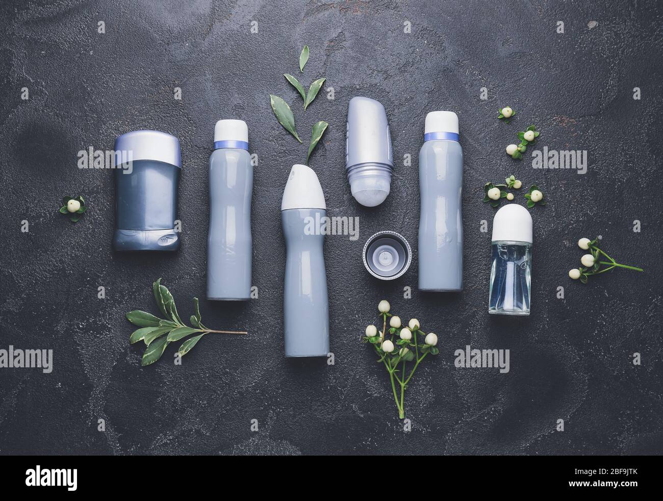 Different deodorants on dark background Stock Photo - Alamy