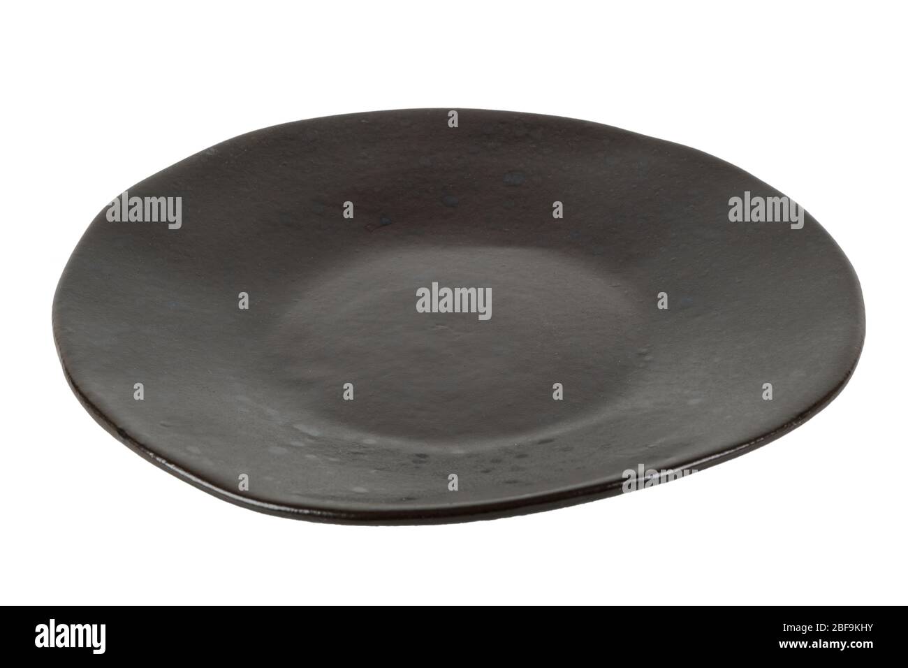 Empty black rustic plate isolated on white Stock Photo - Alamy