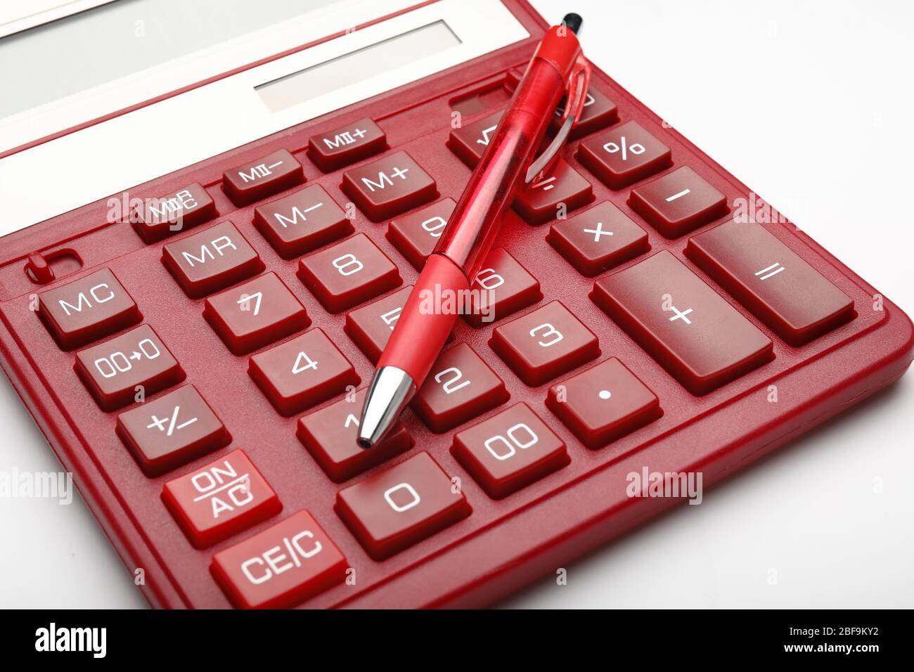 Modern calculator with pen on white background Stock Photo - Alamy