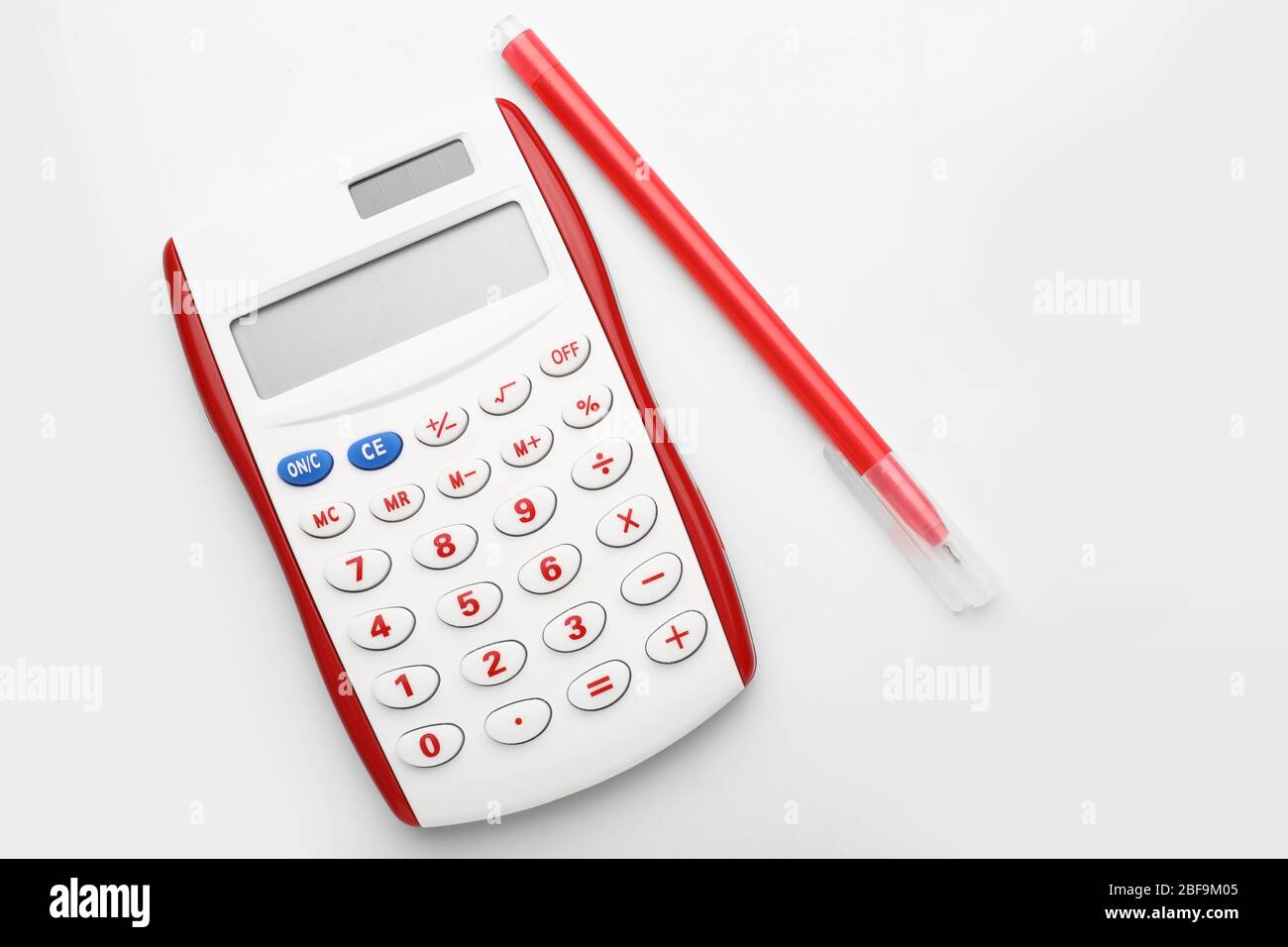 Modern calculator with pen on white background Stock Photo - Alamy