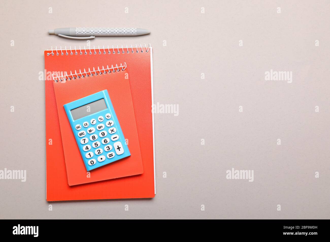 Modern calculator with stationery on grey background Stock Photo - Alamy