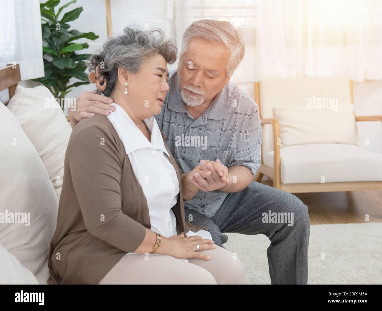 Sick asian senior woman or grandmother is fainted and fallen on floor ...