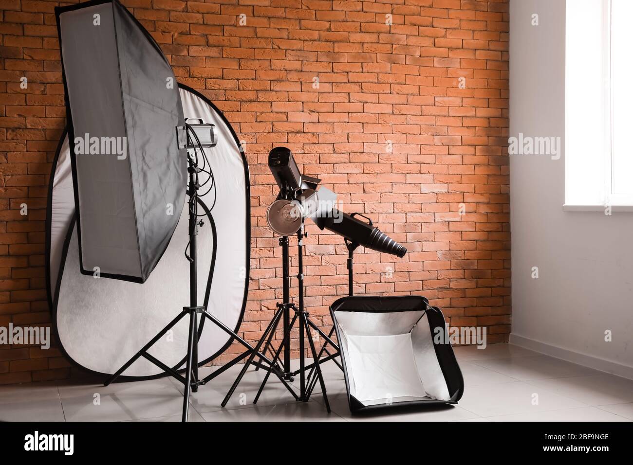 Interior of modern photo studio with brick wall Stock Photo - Alamy