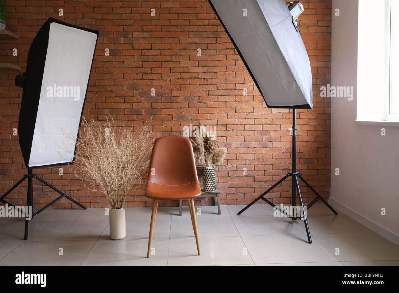Interior of modern photo studio with brick wall Stock Photo - Alamy