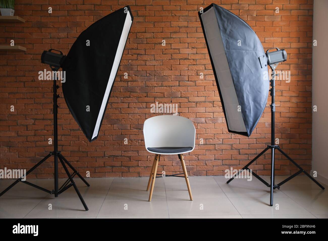 Interior of modern photo studio with brick wall Stock Photo - Alamy