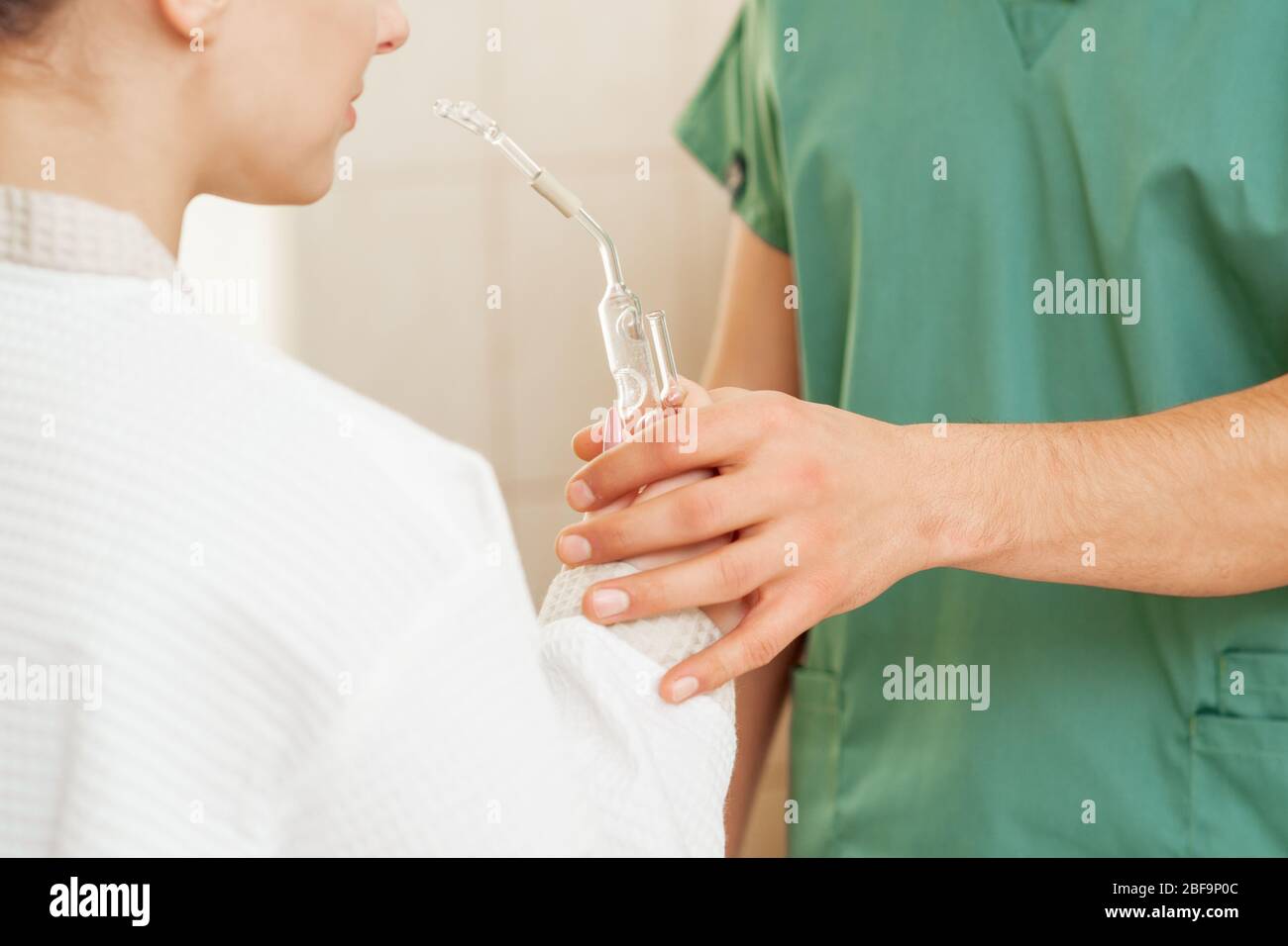 Woman receiving nasal inhalation in nose with essential oil in spa ...