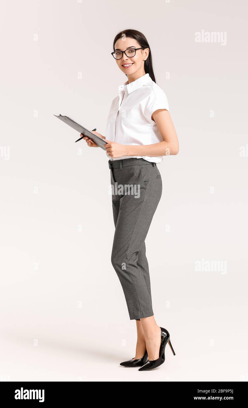 Beautiful young secretary on white background Stock Photo - Alamy