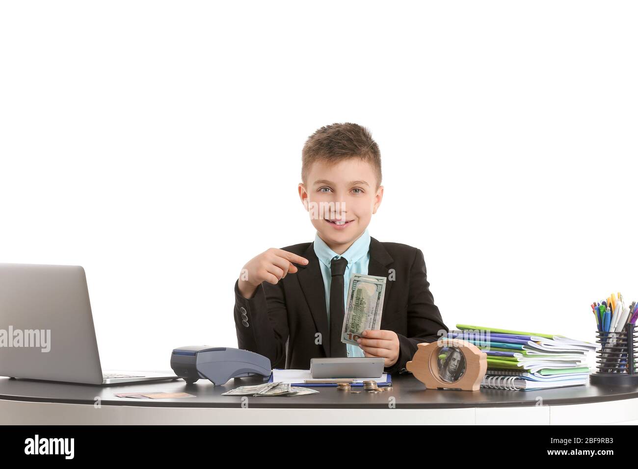 Little accountant at table against white background Stock Photo - Alamy