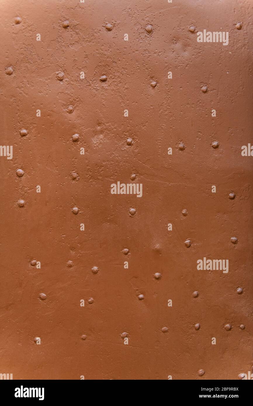 Rivets on metal surface background painted brown Stock Photo - Alamy
