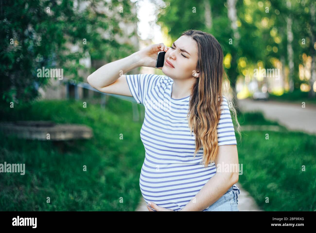 Pregnant woman with contractions feeling pain calling ambulance with ...