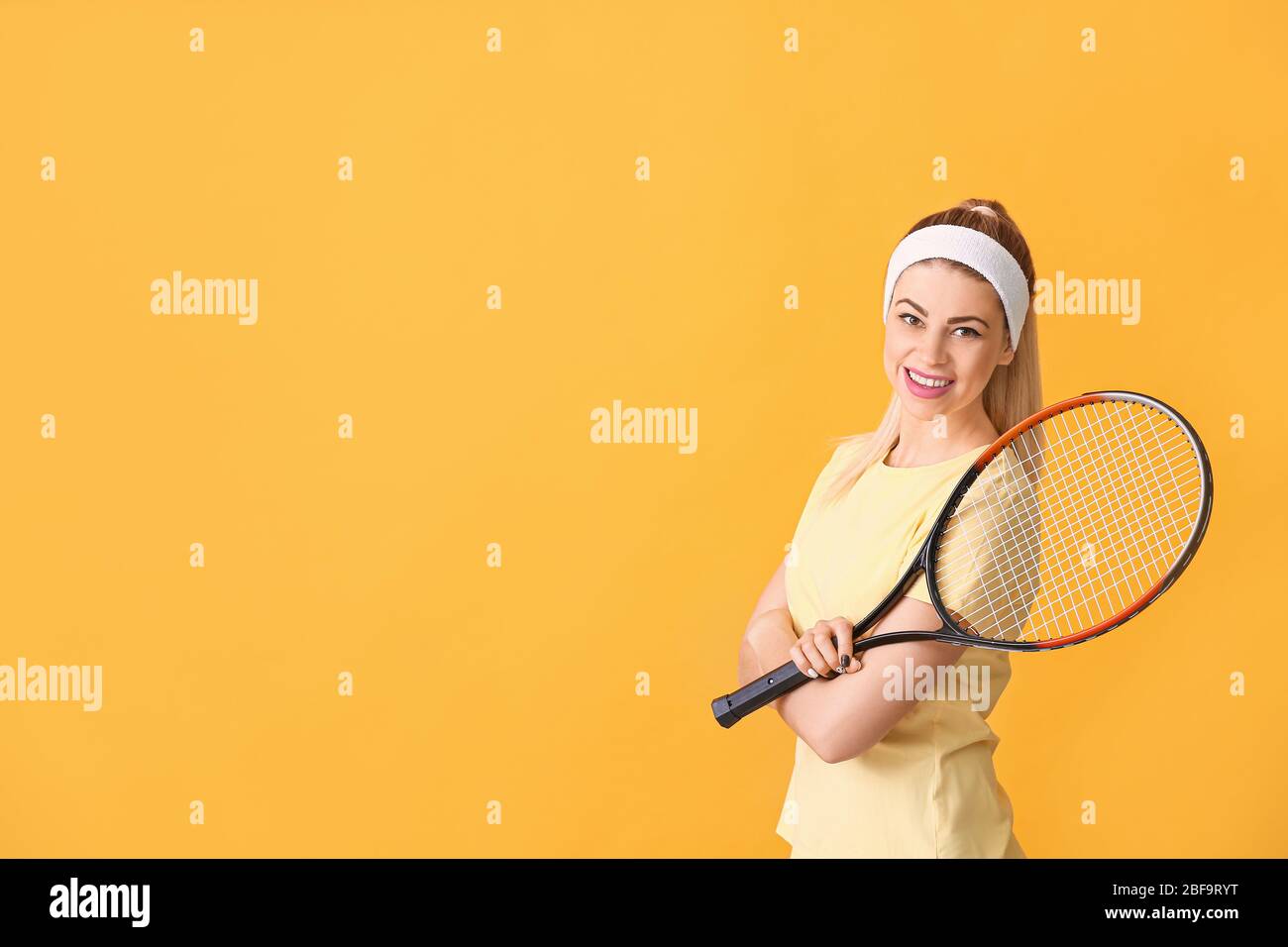 Portrait of beautiful tennis player on color background Stock Photo - Alamy