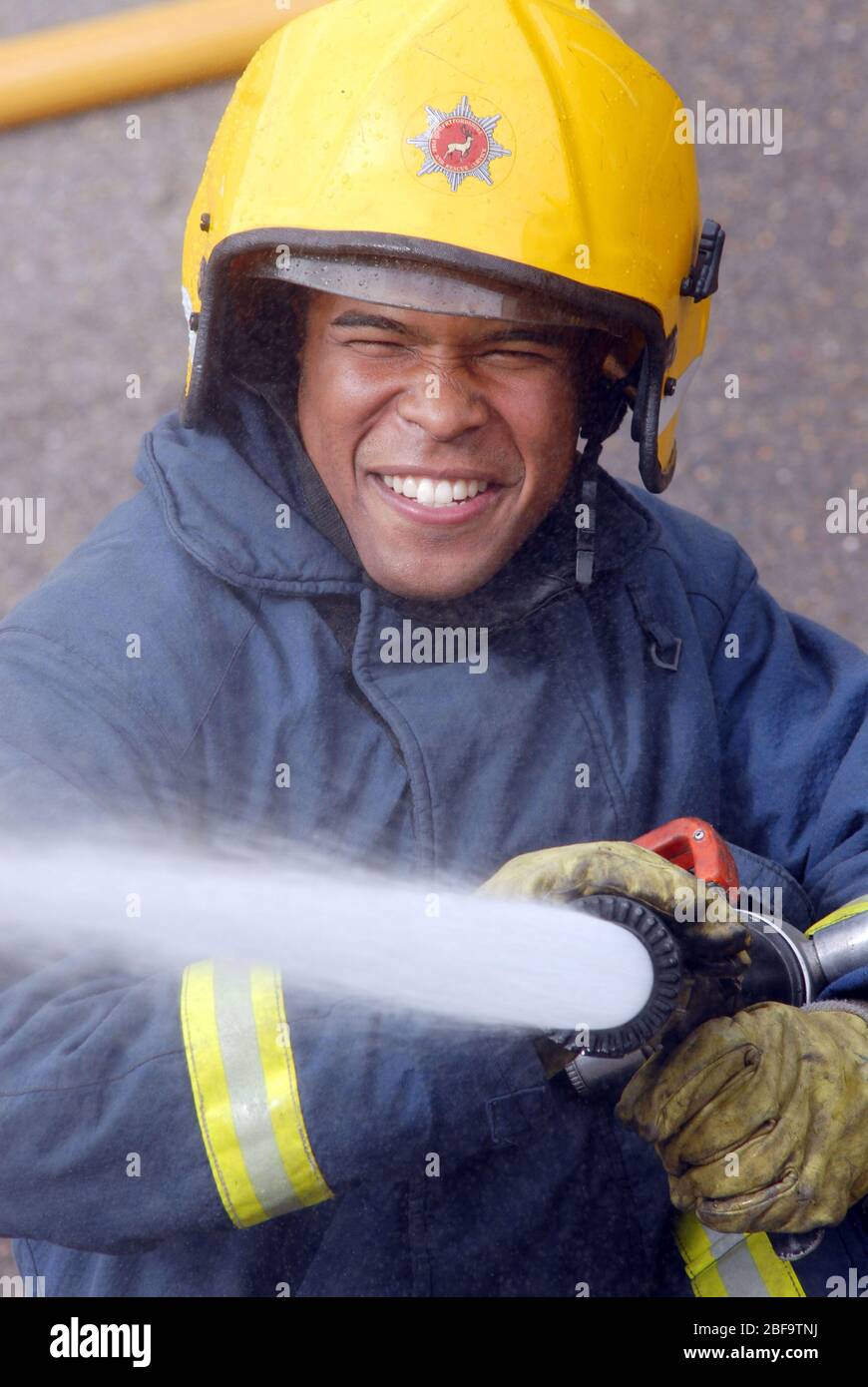 A fireman extinguishing a flame(Model released Stock Photo - Alamy