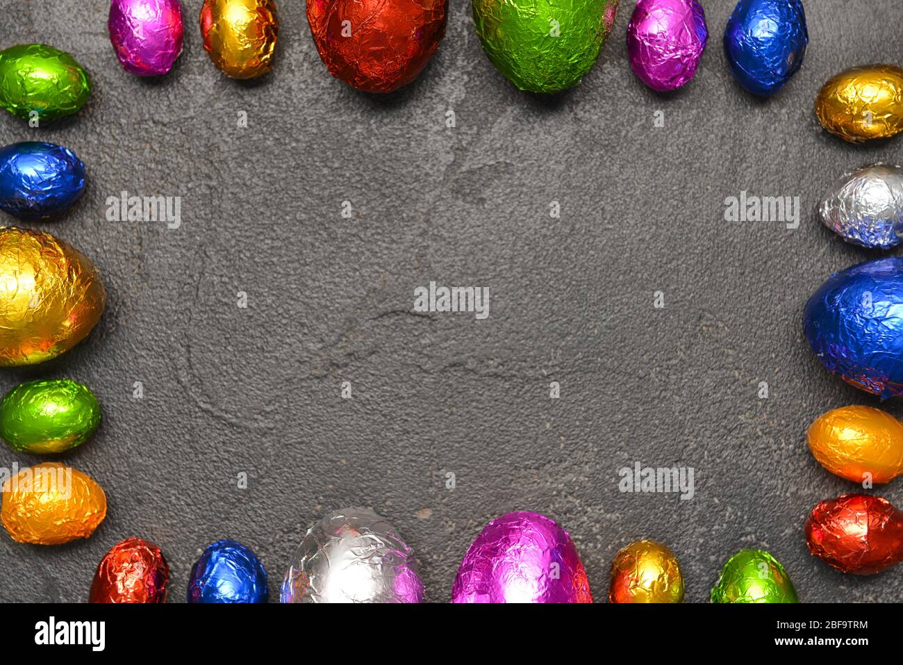 Frame made of sweet chocolate eggs on grey background Stock Photo - Alamy