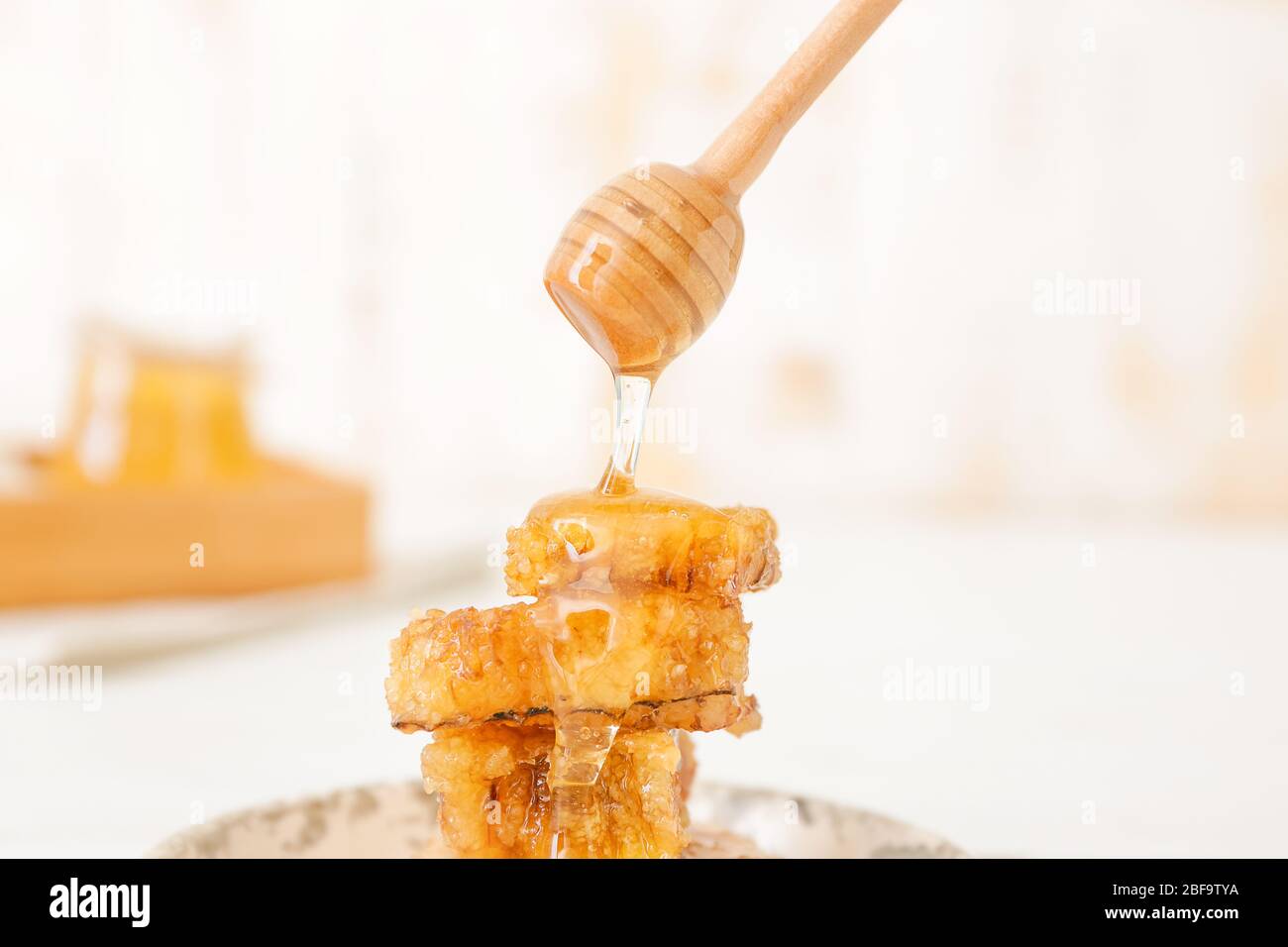 Honeycombs pouring honey from wooden hi-res stock photography and ...
