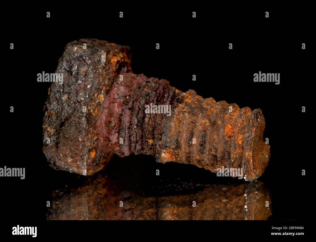 Rusted screw closeup view on black background Stock Photo - Alamy