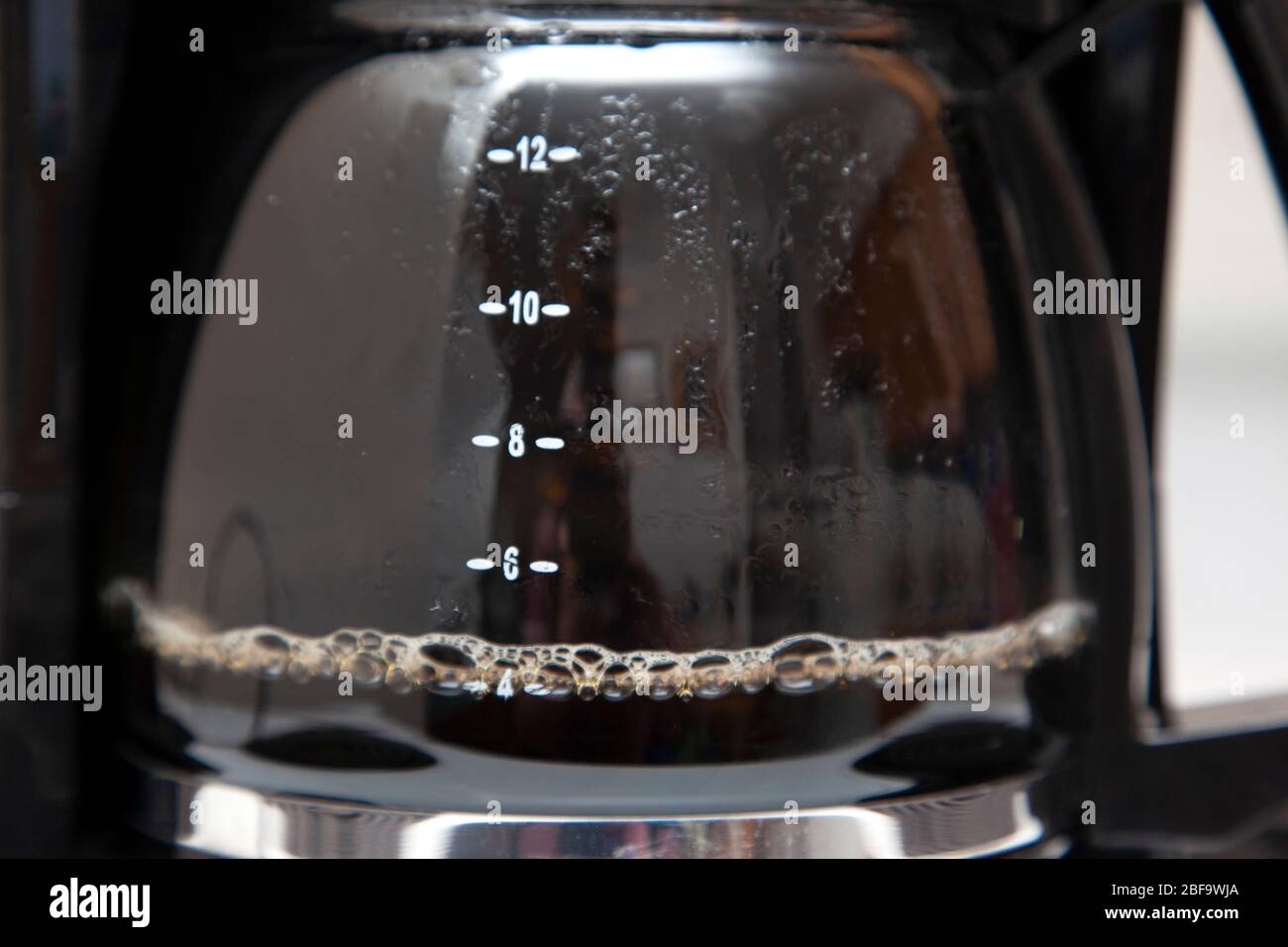glass coffee drip maker bubbling in the kitchen ready for drinking ...