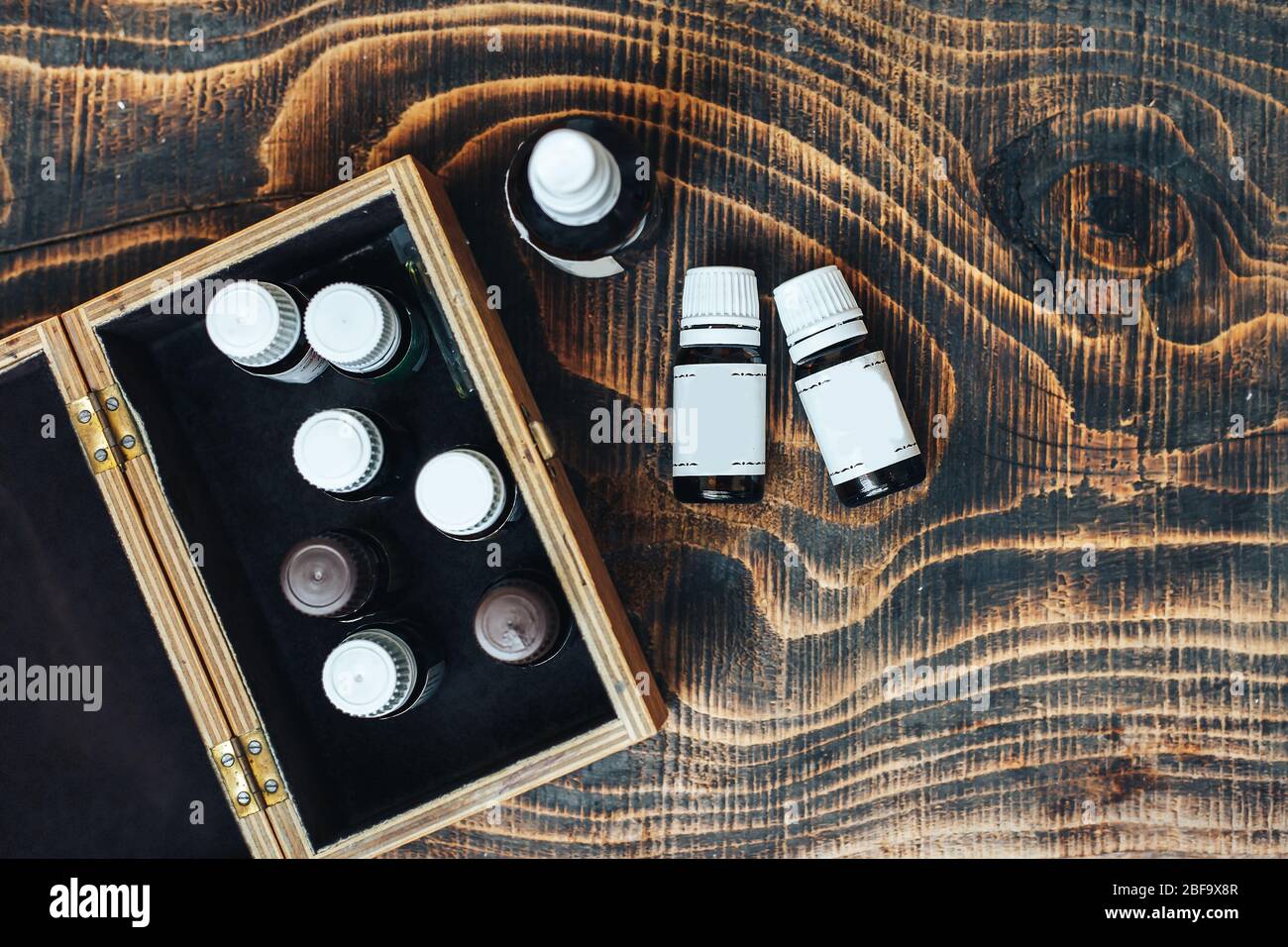 Glass bottles with different scents and exotic types of essential oils ...