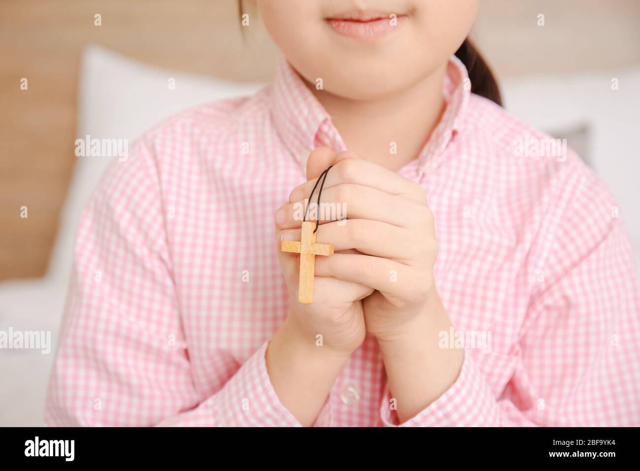 Cute little girl praying at home, closeup Stock Photo - Alamy