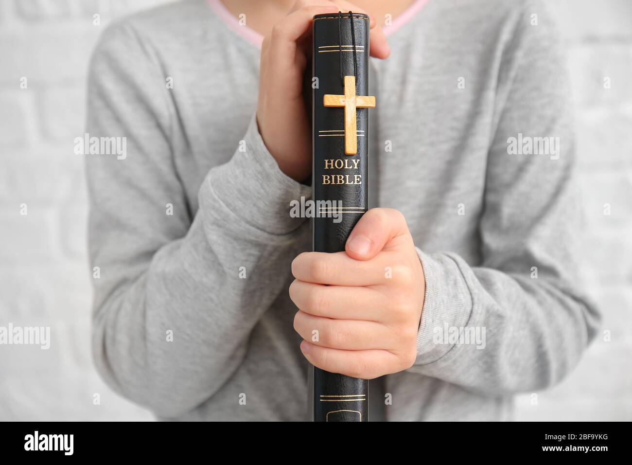 Cute little girl praying on white background, closeup Stock Photo - Alamy