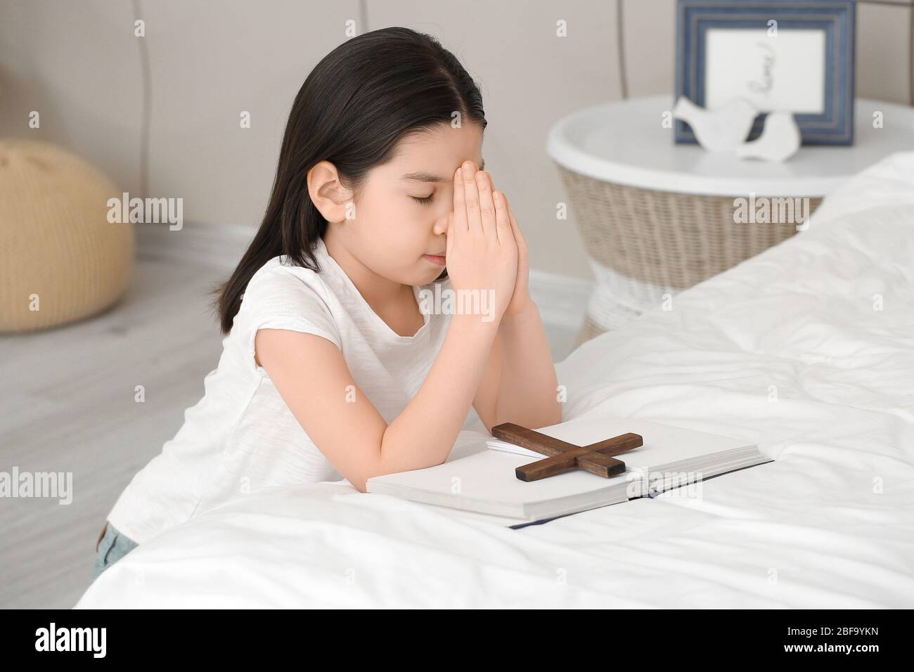 Cute little Asian girl praying at home Stock Photo - Alamy