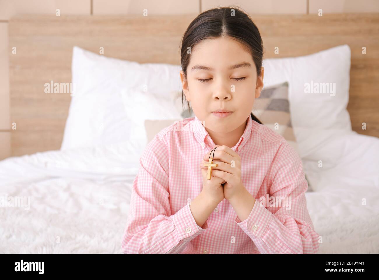 Cute little Asian girl praying at home Stock Photo - Alamy