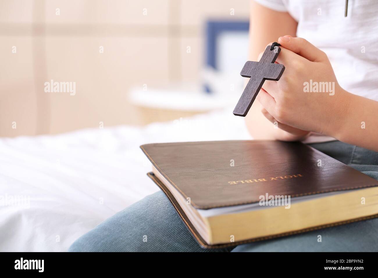 Cute little girl praying at home, closeup Stock Photo - Alamy