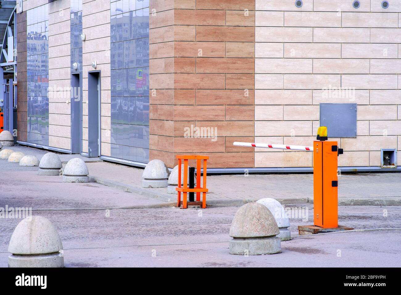 Concrete road barriers and a pneumatic barrier in orange color with a ...