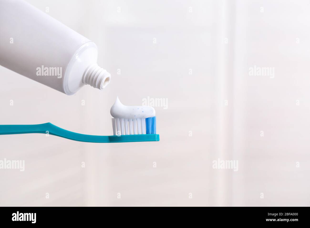 Tooth brush with paste in bathroom Stock Photo - Alamy