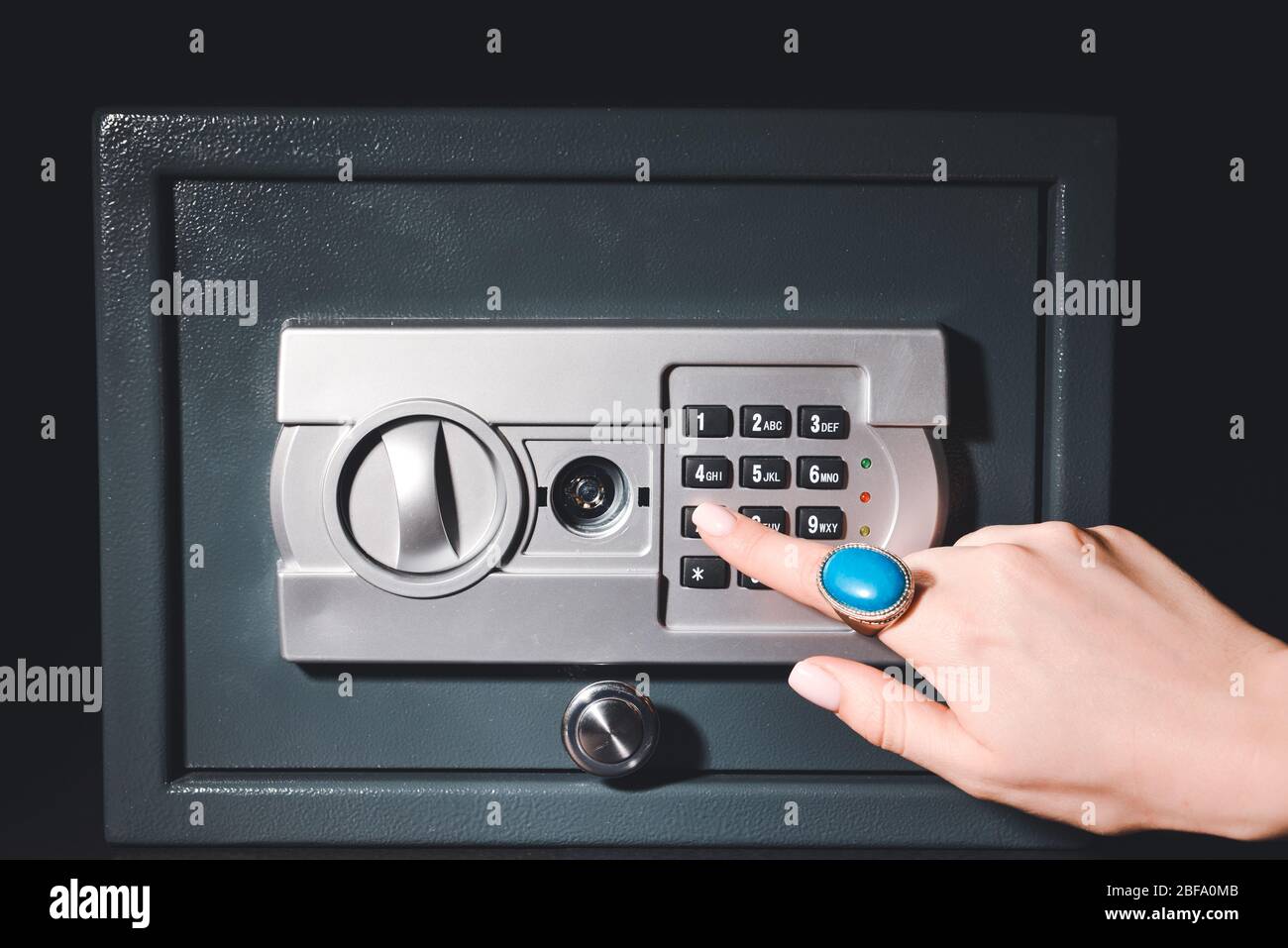 Woman opening safe box on dark background Stock Photo - Alamy