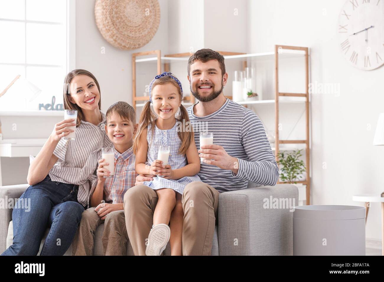 Happy family drinking milk at home Stock Photo - Alamy
