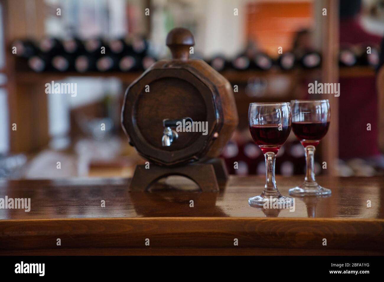 Red wine in two cups and Wine Keg on vintage Bar desk. Red grape wine ...