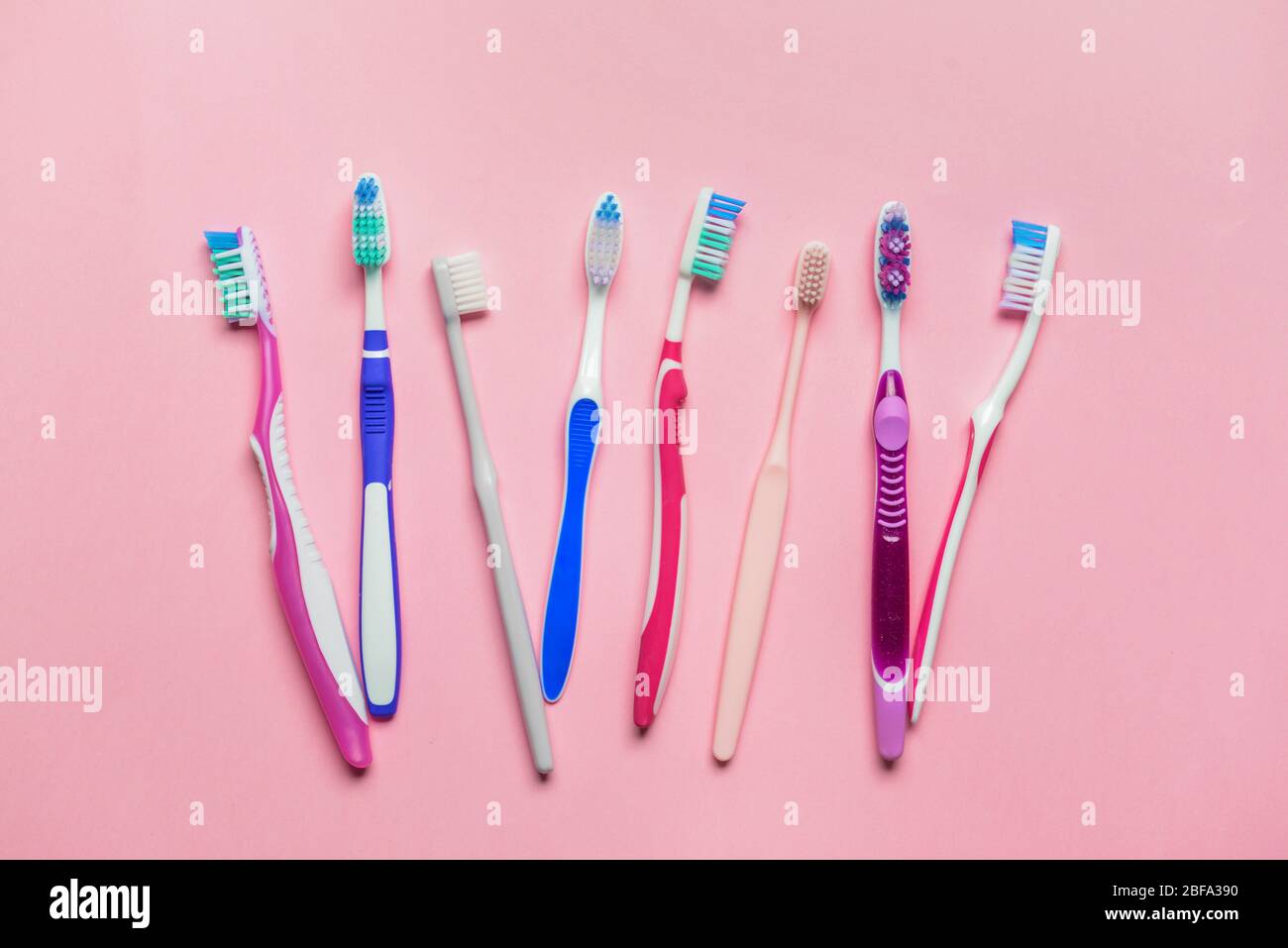Tooth brushes on color background Stock Photo - Alamy