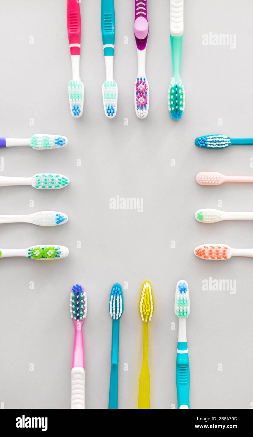 Many tooth brushes on light background Stock Photo - Alamy