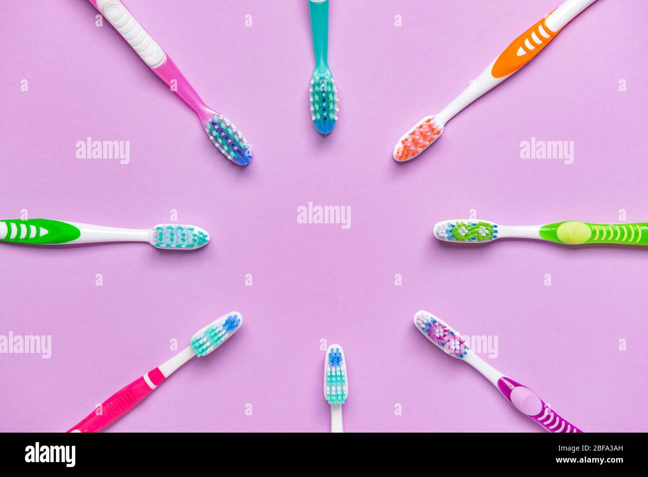 Tooth brushes on color background Stock Photo - Alamy