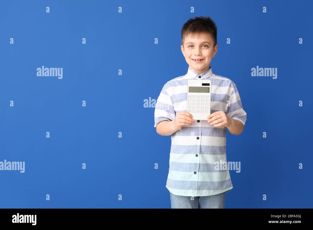 Little boy with calculator on color background Stock Photo - Alamy