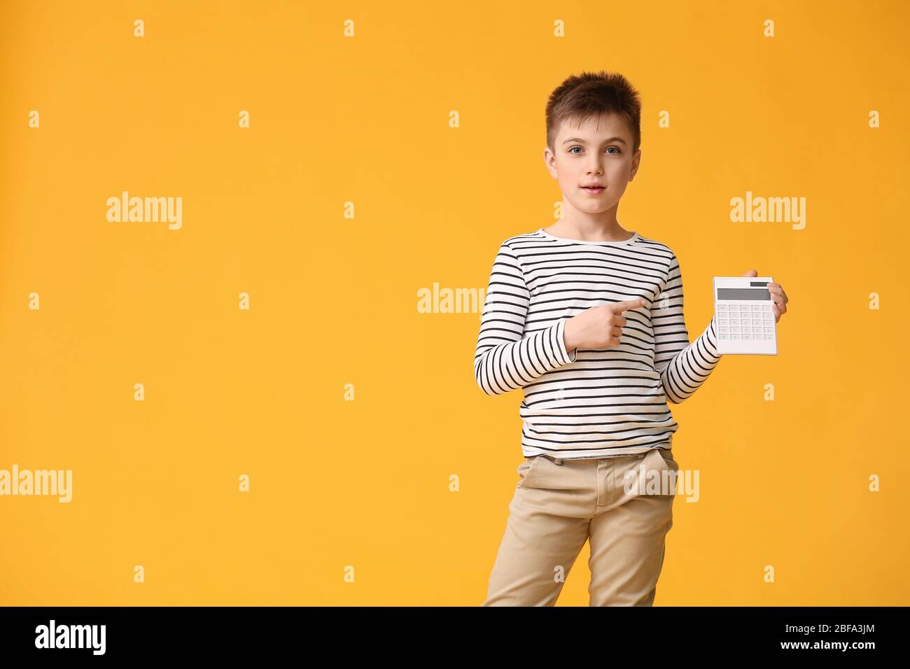 Little boy with calculator on color background Stock Photo - Alamy