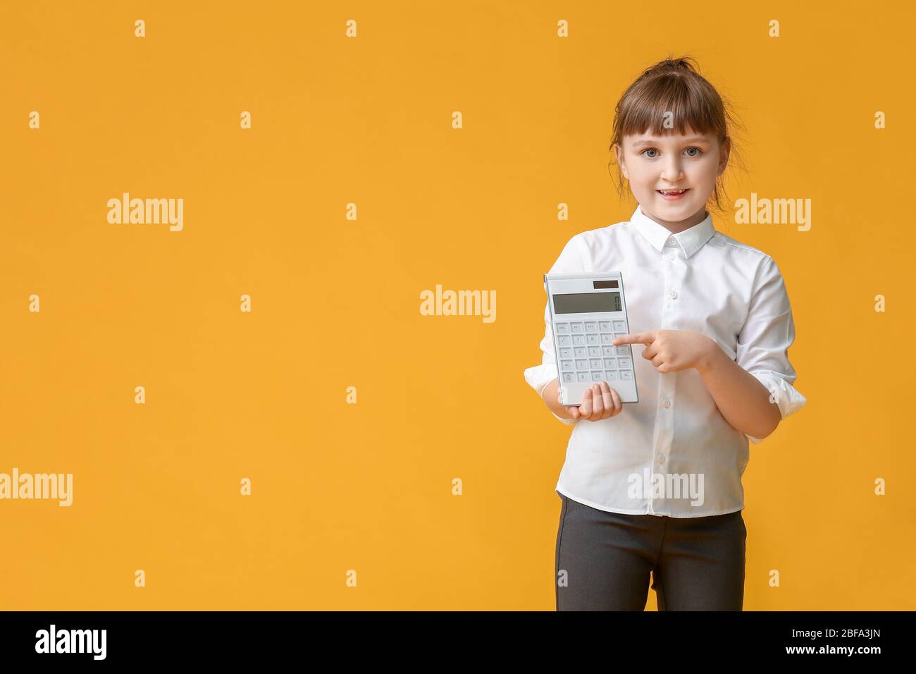 Little girl with calculator on color background Stock Photo - Alamy