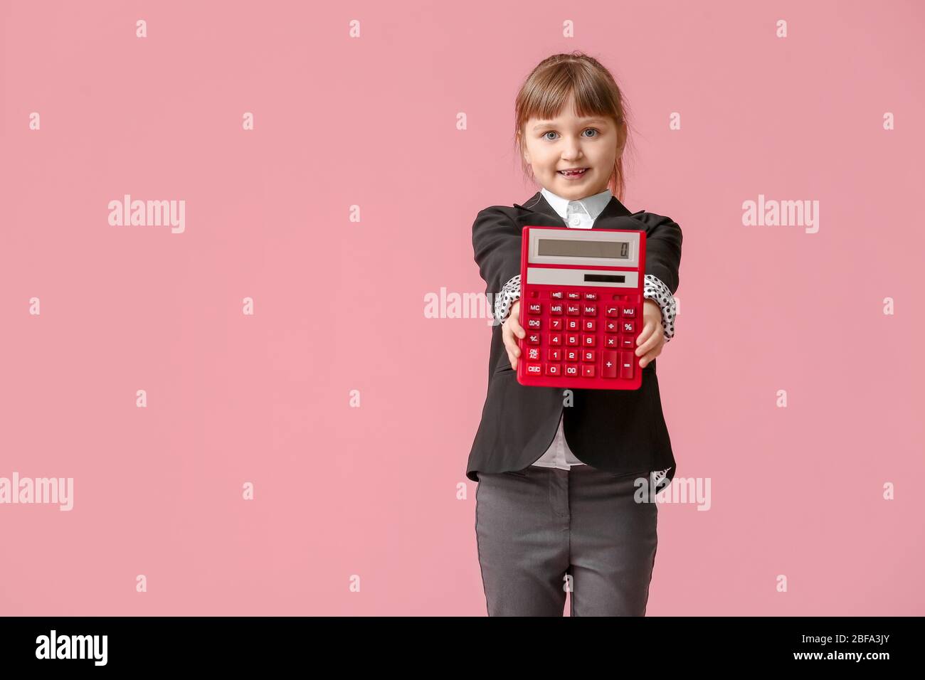 Little girl with calculator on color background Stock Photo - Alamy