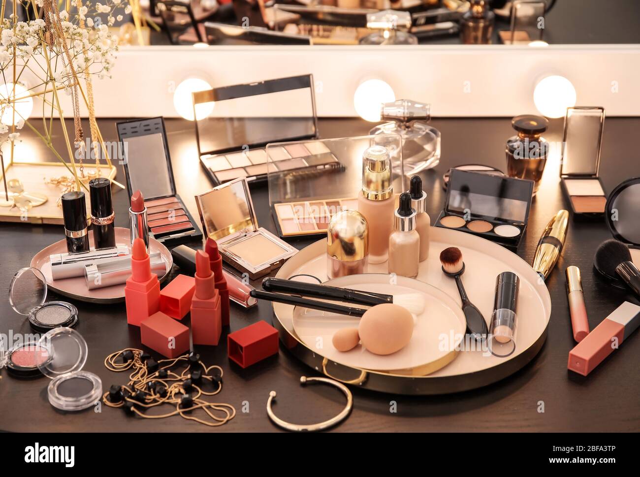 Different cosmetics on table of makeup artist Stock Photo - Alamy