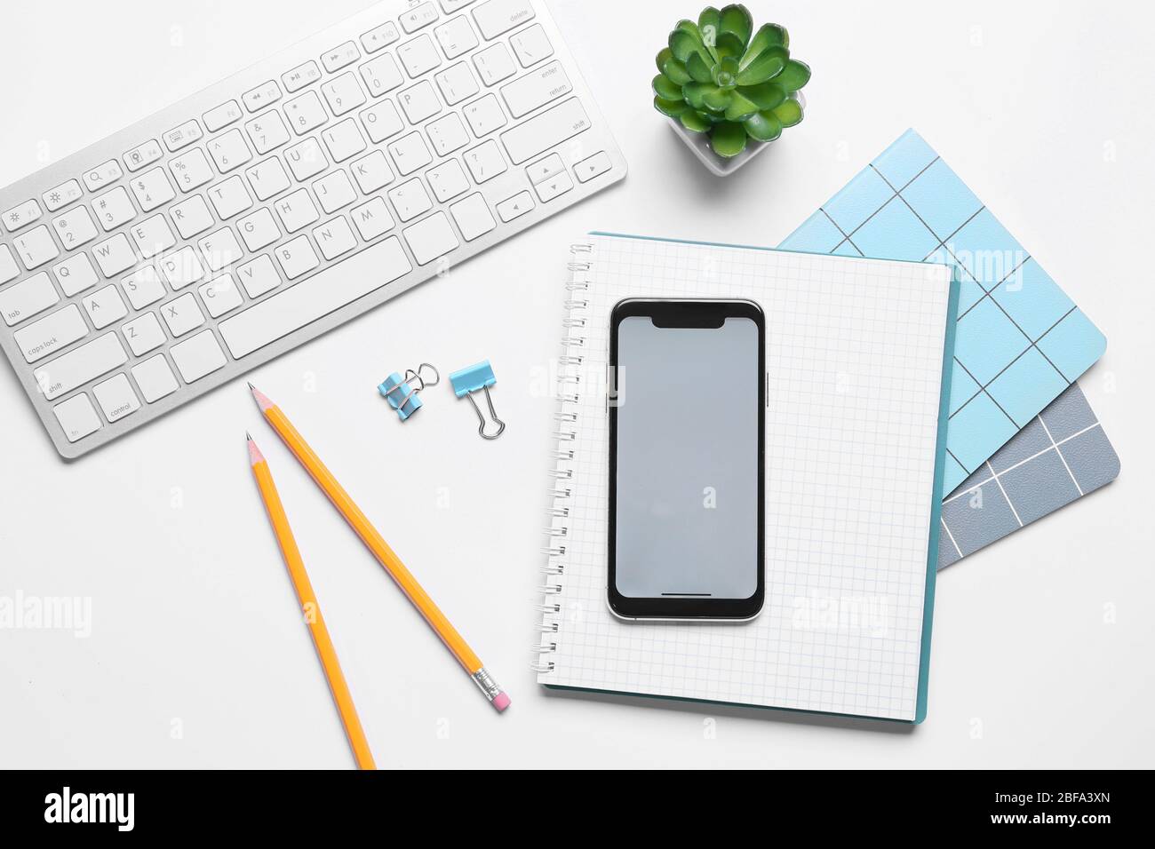 Mobile phone, PC keyboard and stationery on white background Stock ...