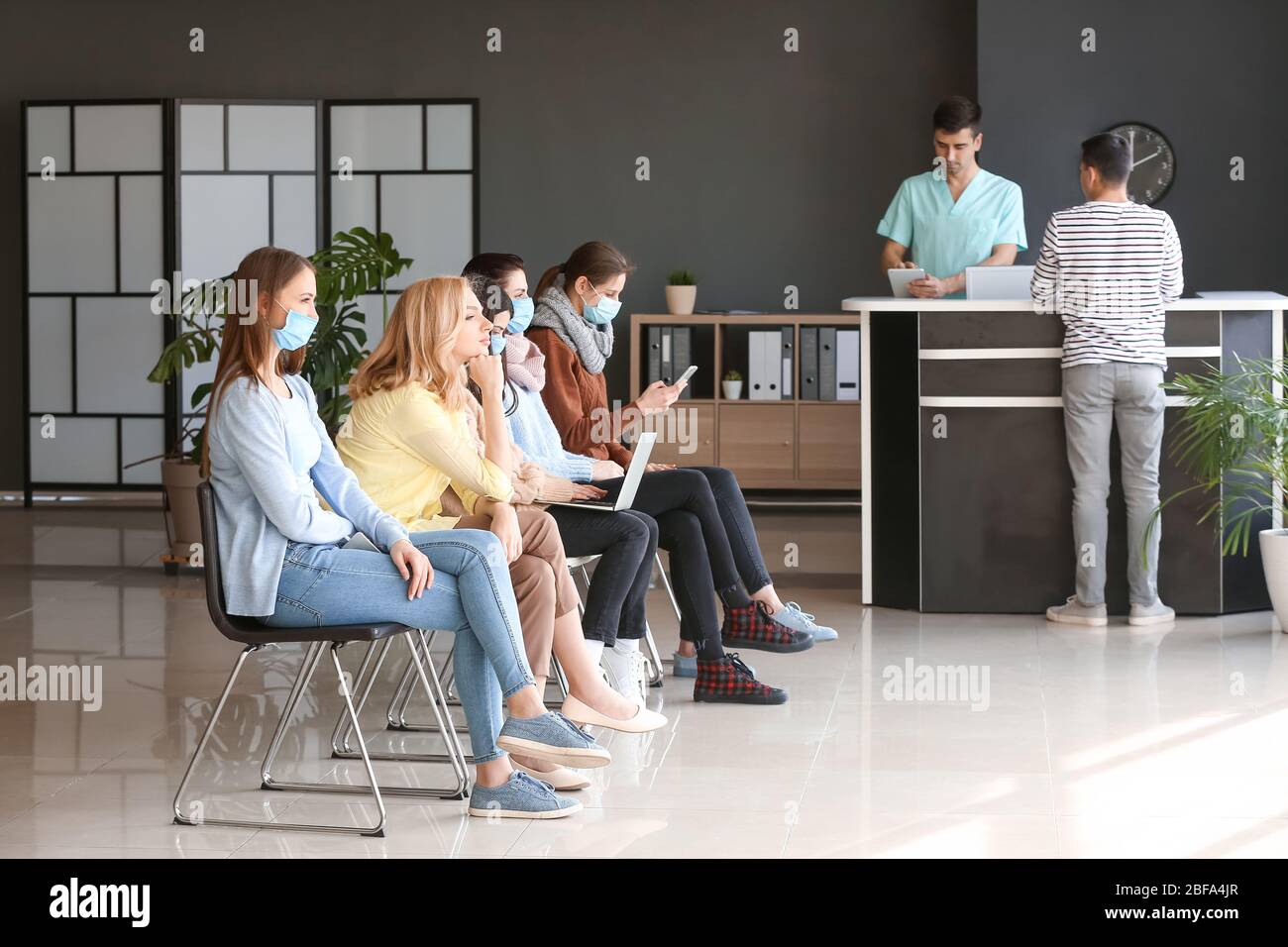 Patients waiting in hall of clinic Stock Photo - Alamy