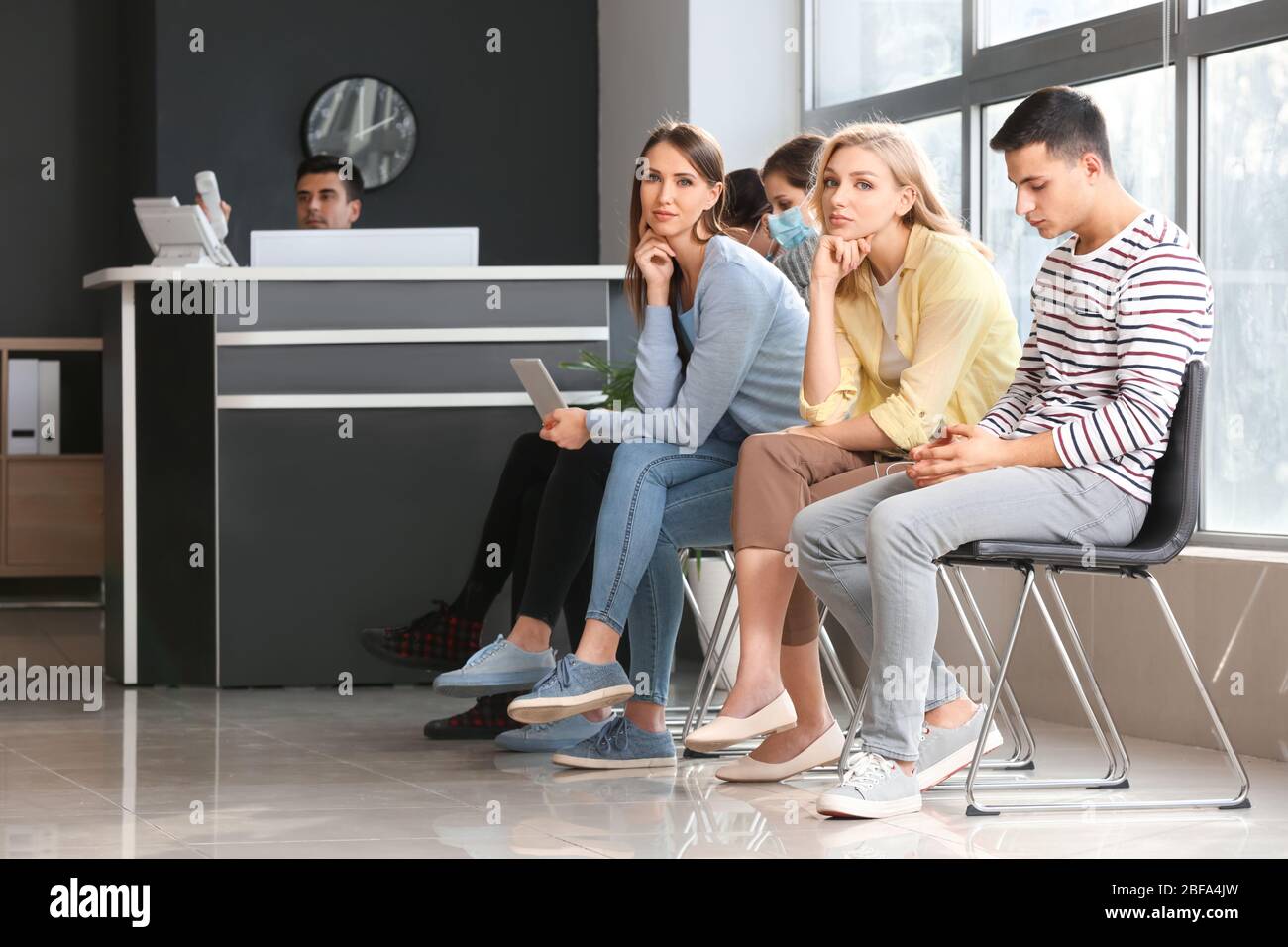 Patients waiting in hall of clinic Stock Photo - Alamy